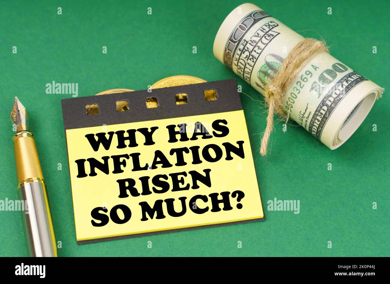 Business concept. On a green surface are a pen, dollars and yellow ...