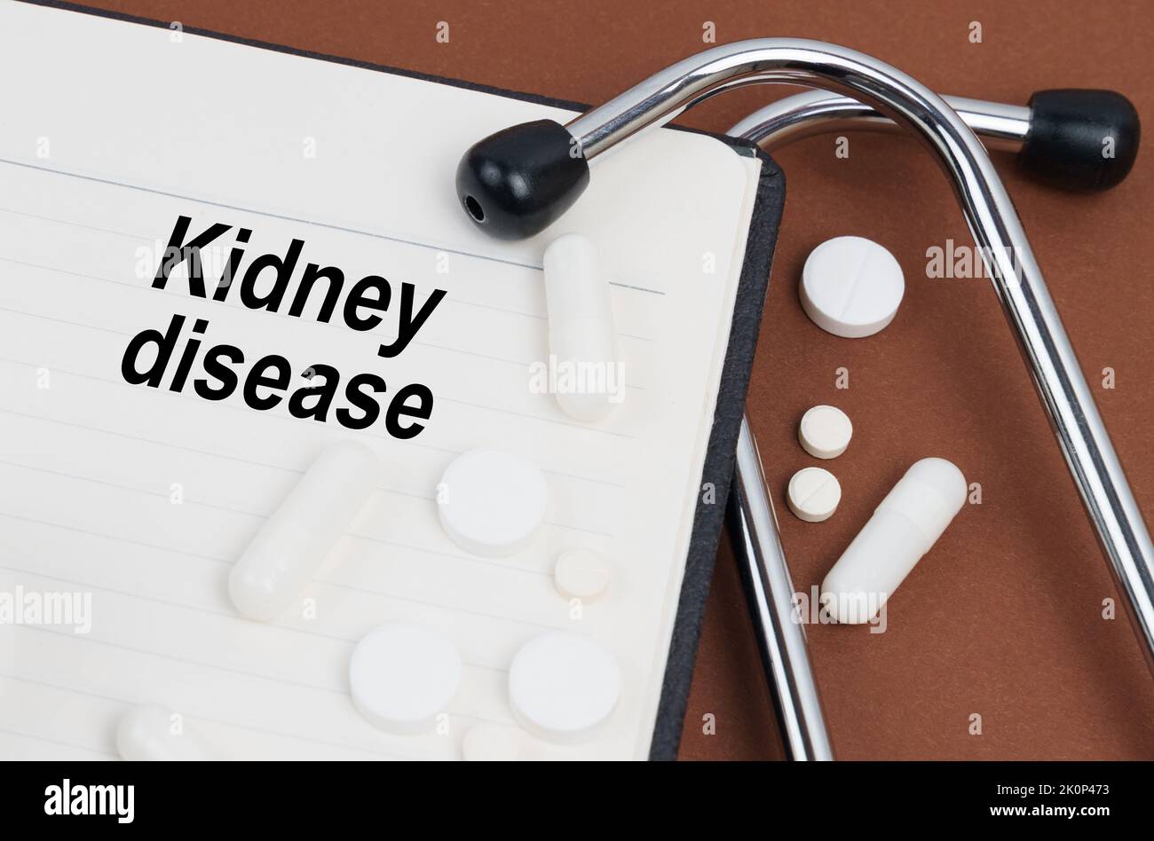 Medical concept. On a brown surface lies a stethoscope, pills and a ...