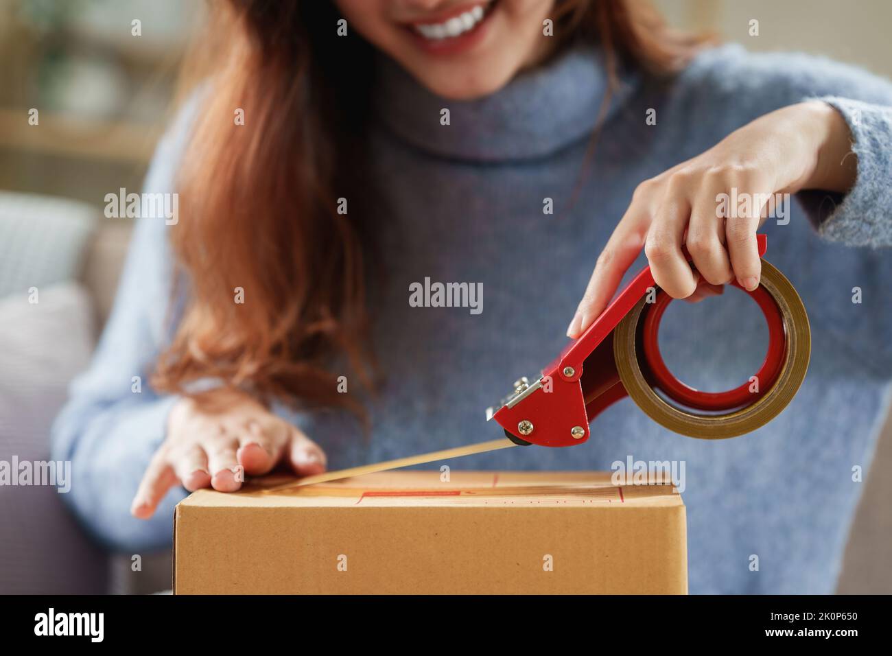 Young entrepreneur packing parcel box and work at home. New generation ...