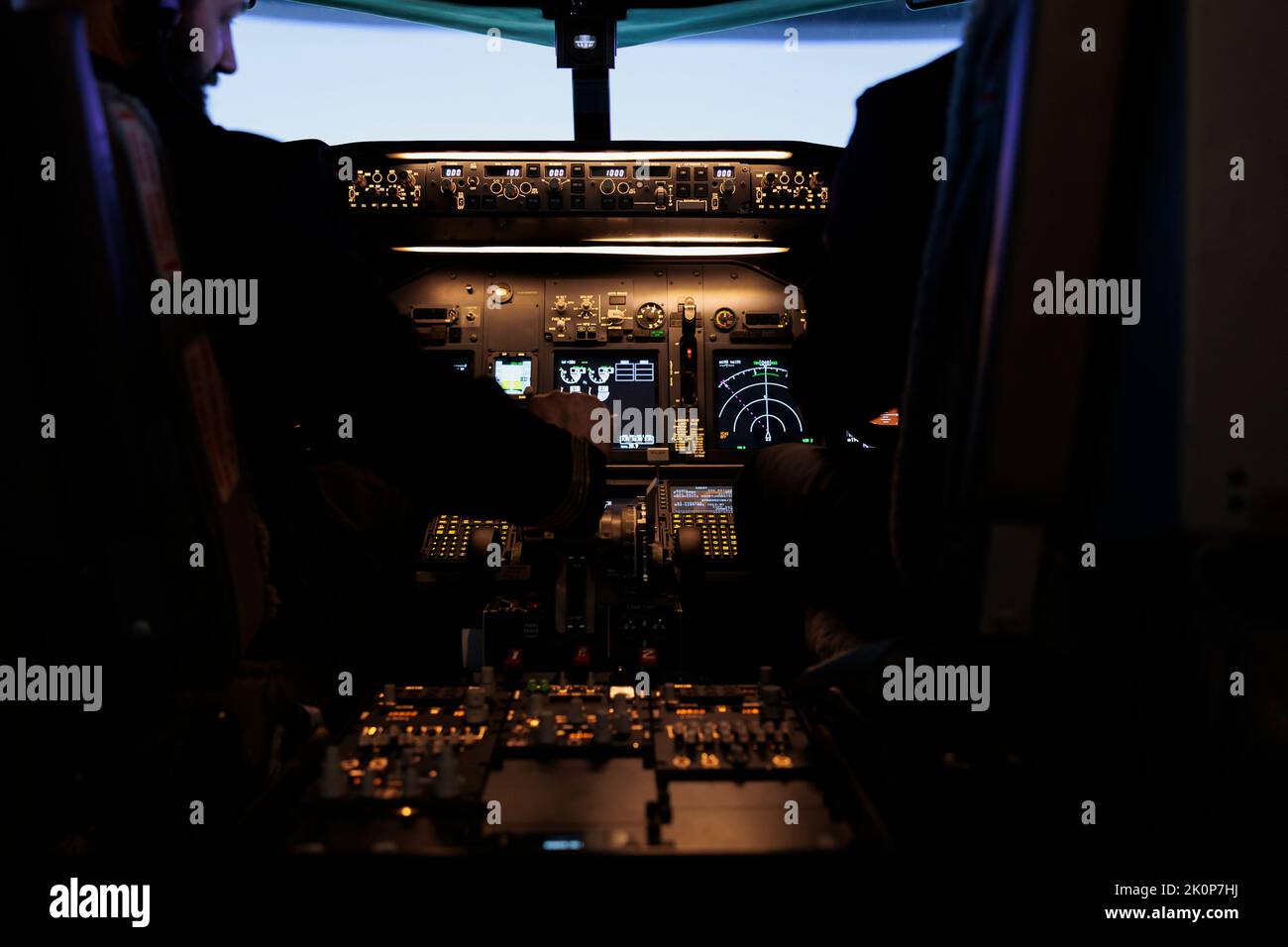 Multiethnic team of captain and pilot switching engine throttle lever ...