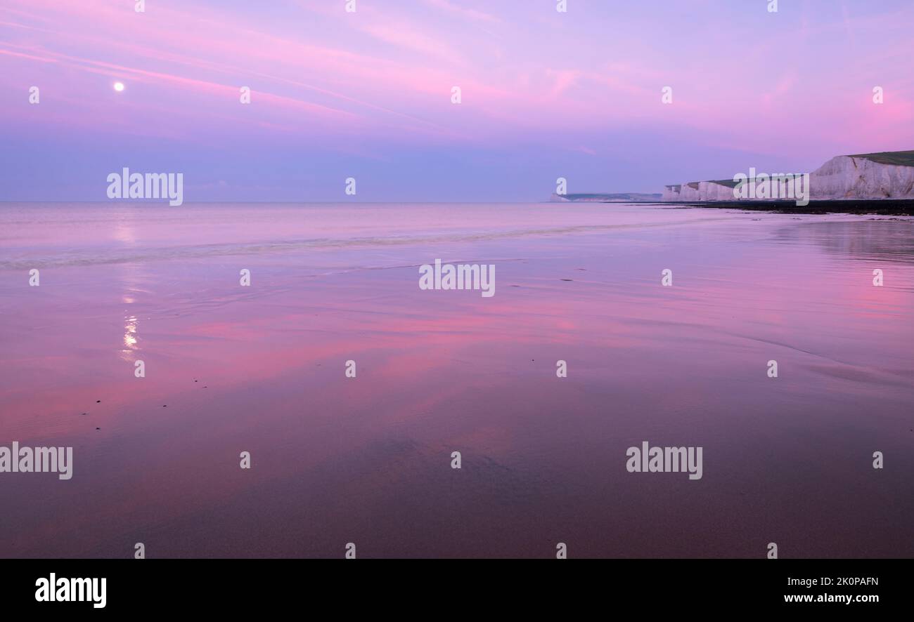 Purple morning blue hour and September full moon setting during low ...