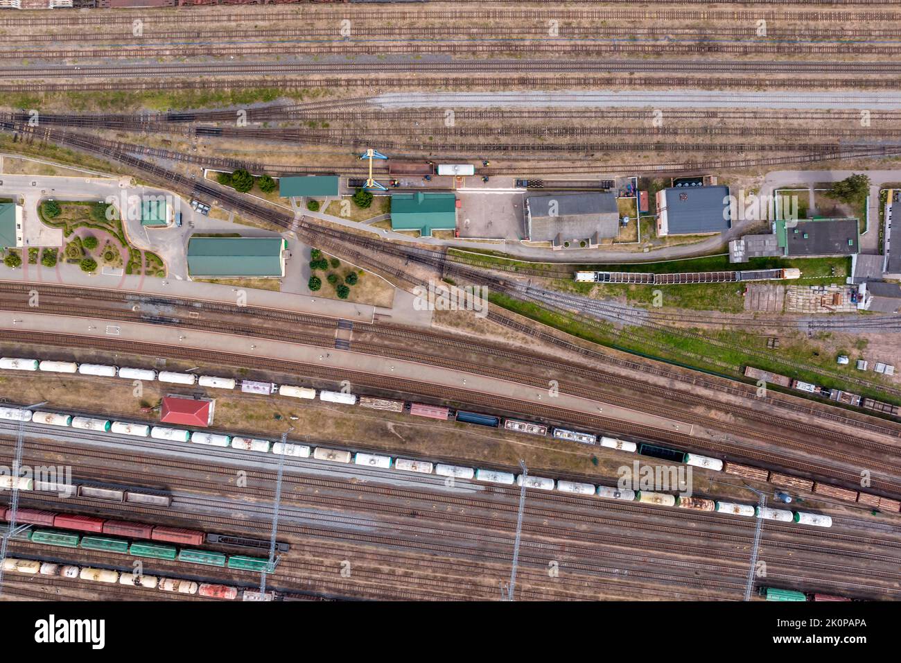 aerial view over long railway freight trains with lots of wagons stand ...