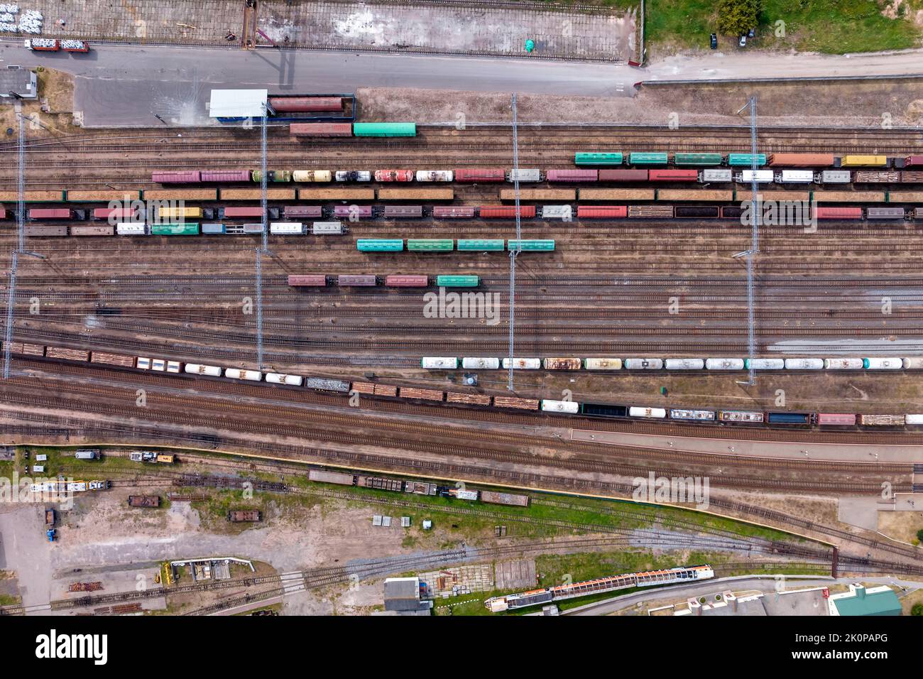 aerial view over long railway freight trains with lots of wagons stand ...