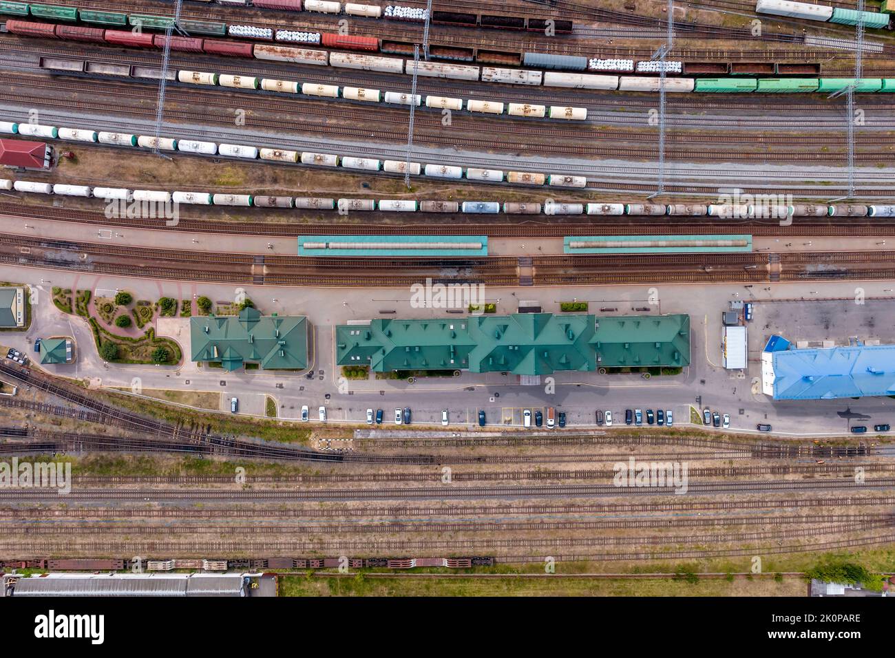 aerial view over long railway freight trains with lots of wagons stand ...