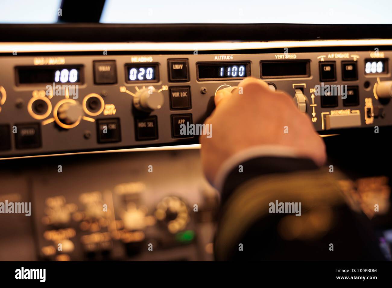 Captain pushing buttons to fix altitude level on control panel command ...