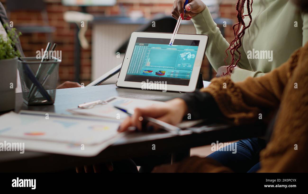 Business people using research infographics on digital tablet to do ...