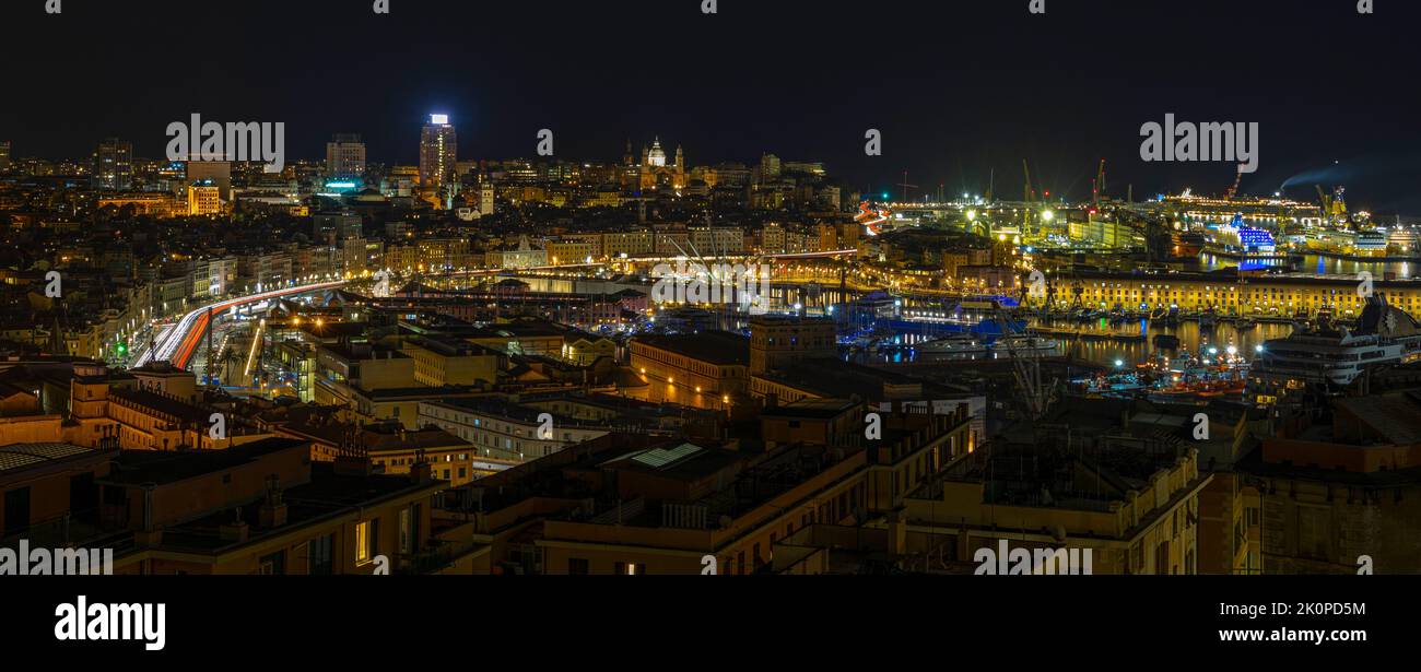 Panoramic view of Genoa at night with the causeway and the buidings of ...