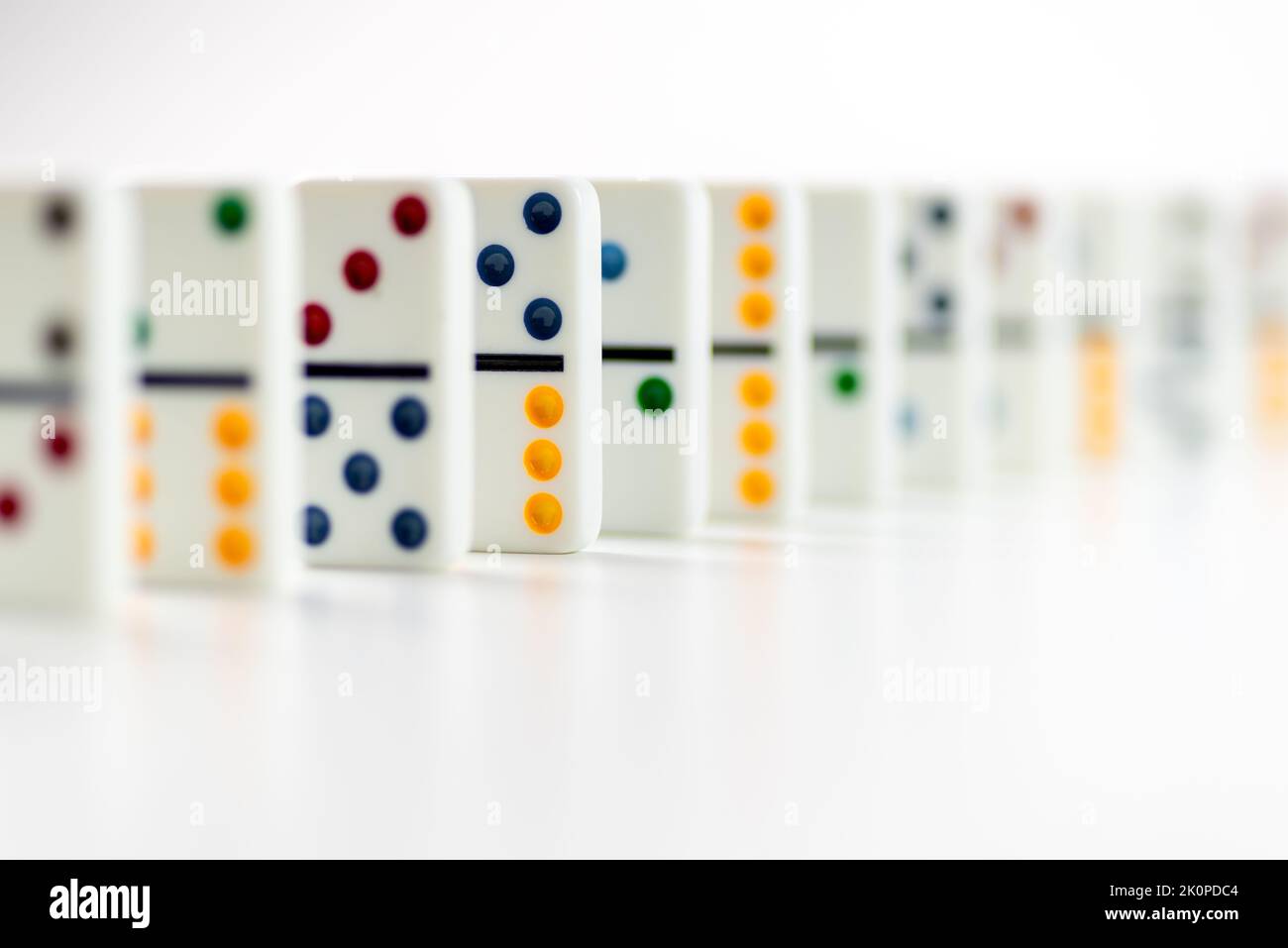 Dominoes. Dominos pieces with colorful dots in row on white background ...