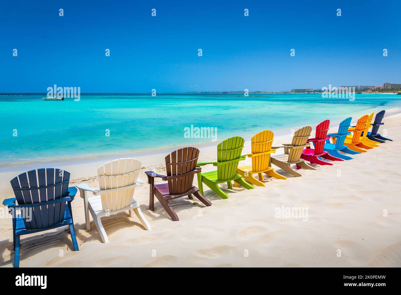 Idyllic Beach With Rustic Adirondack Chairs In Aruba Dutch Antilles