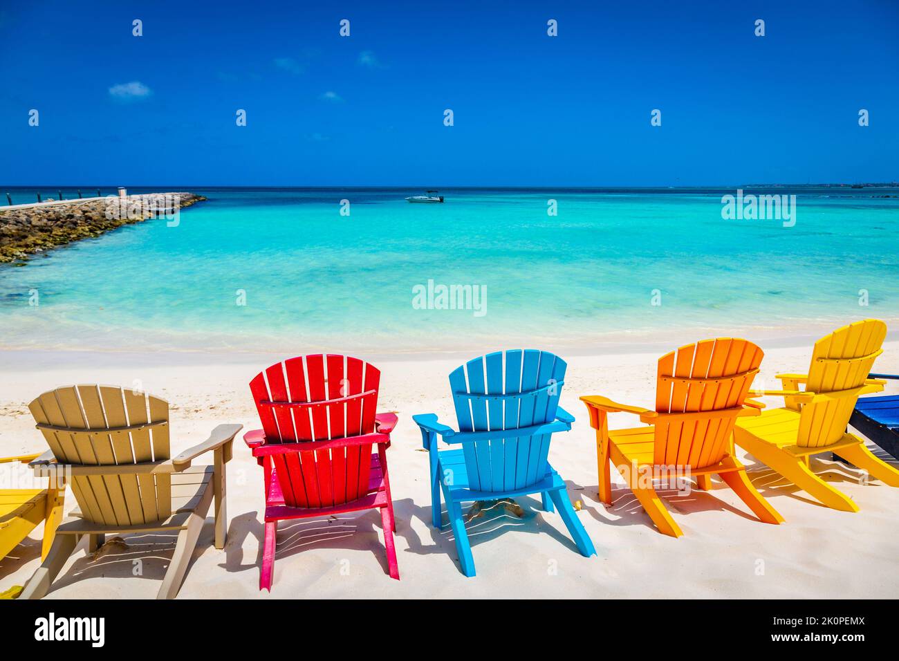 Idyllic beach with rustic adirondack chairs in Aruba, Dutch Antilles ...