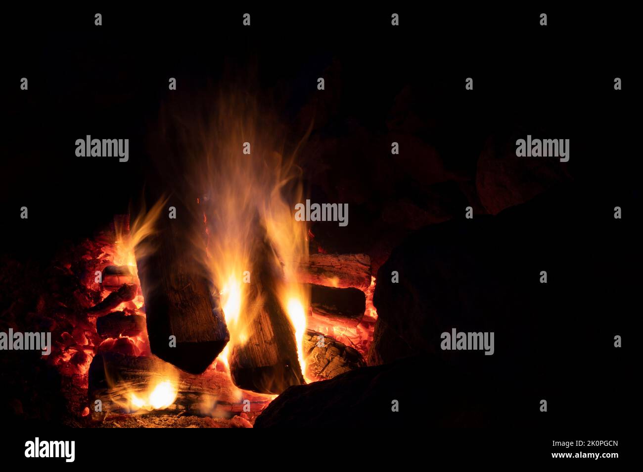 Campfire at night that is surrounded by rocks Stock Photo - Alamy
