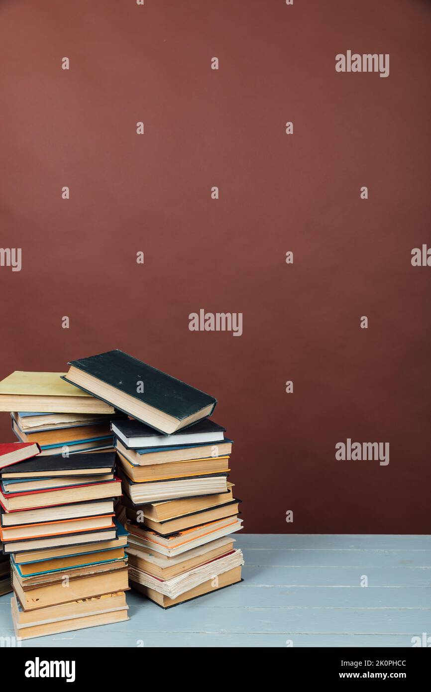 a stack of old instructional books on a brown background Stock Photo ...