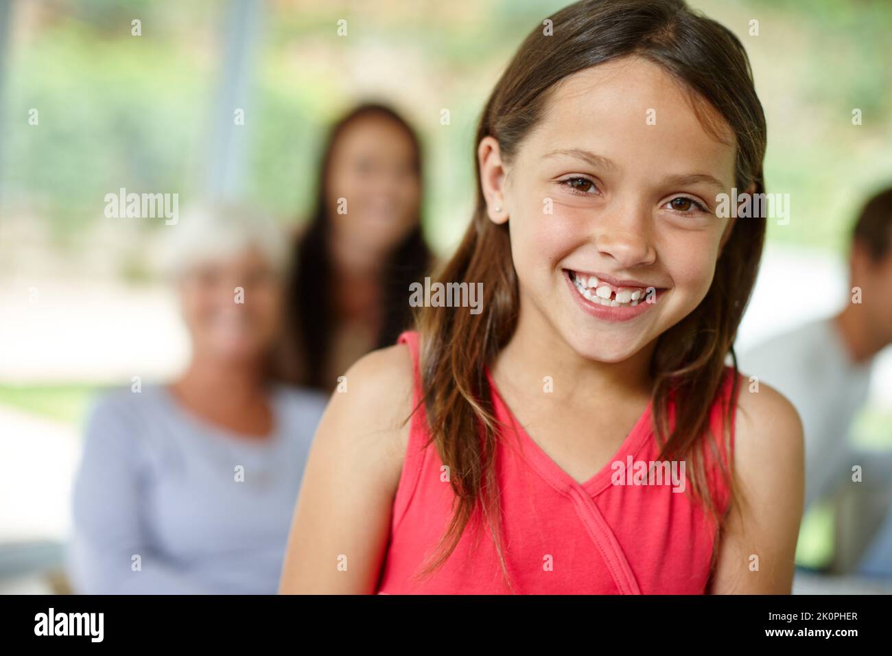 Growing up in a happy home. Portrait of a cute little girl with her ...