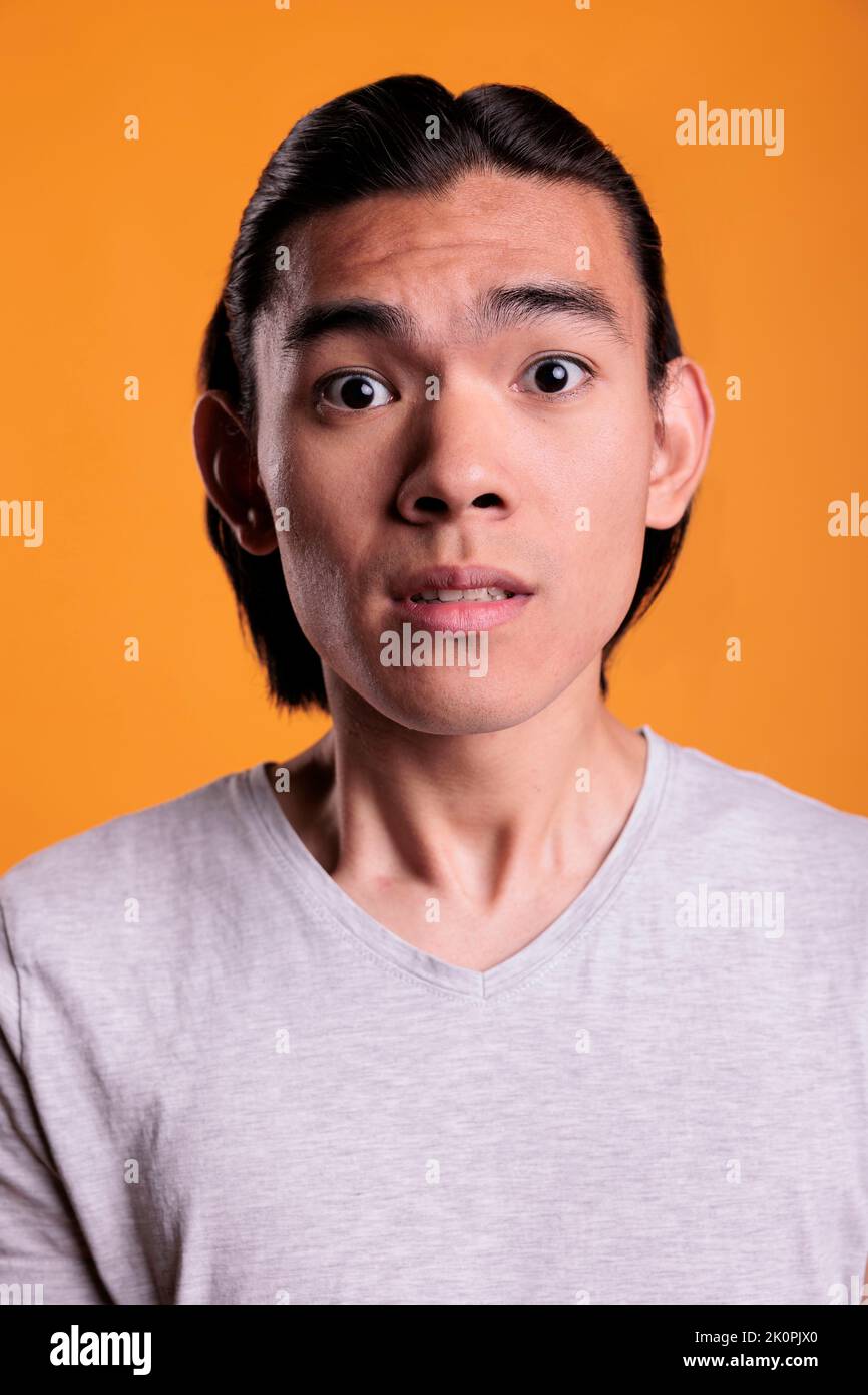 Shocked young asian man facial expression closeup. Surprised teenager ...