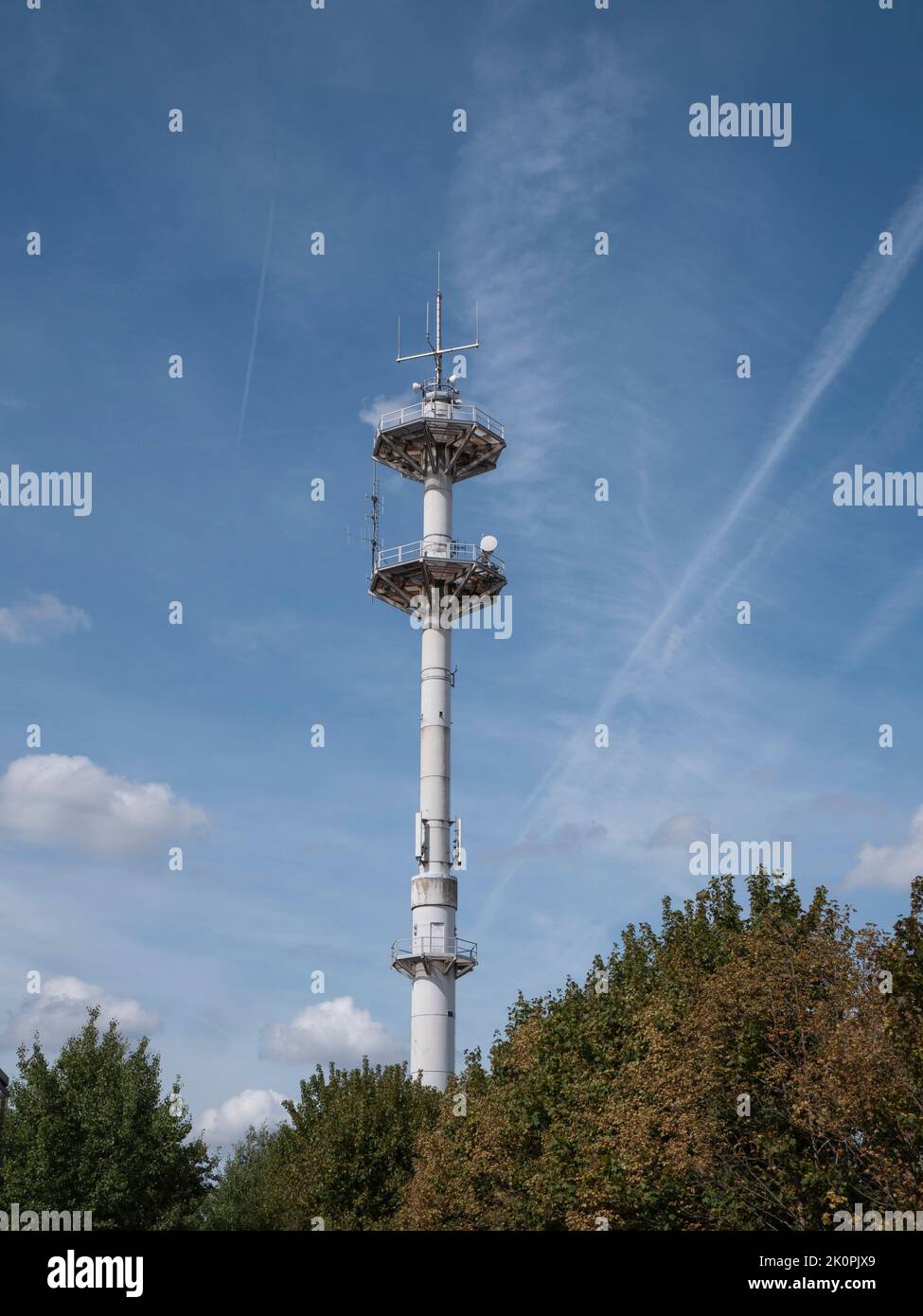 mobile phone tower in nature with a blue cloudy sky as background Stock ...