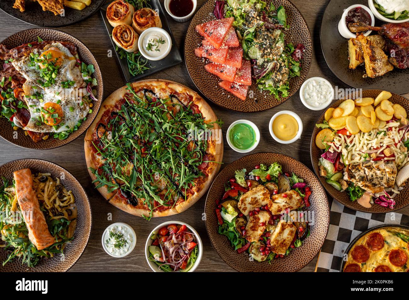 Business lunch in cafe. Tasty food on table. Pizza with greenery ...