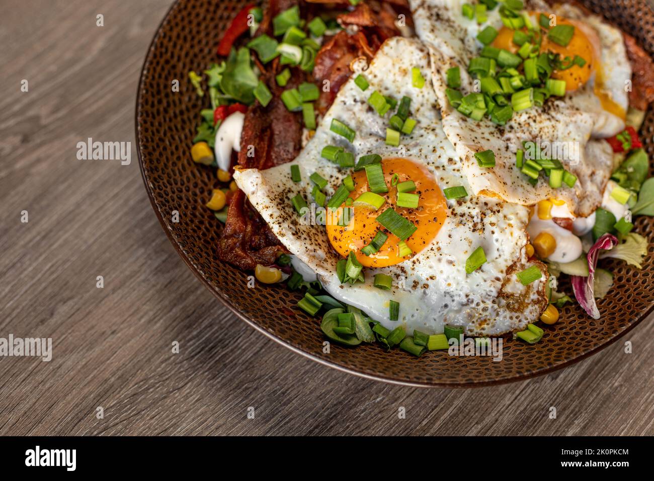 Close up tasty, delicious and greasy fried eggs with meat and bacon ...