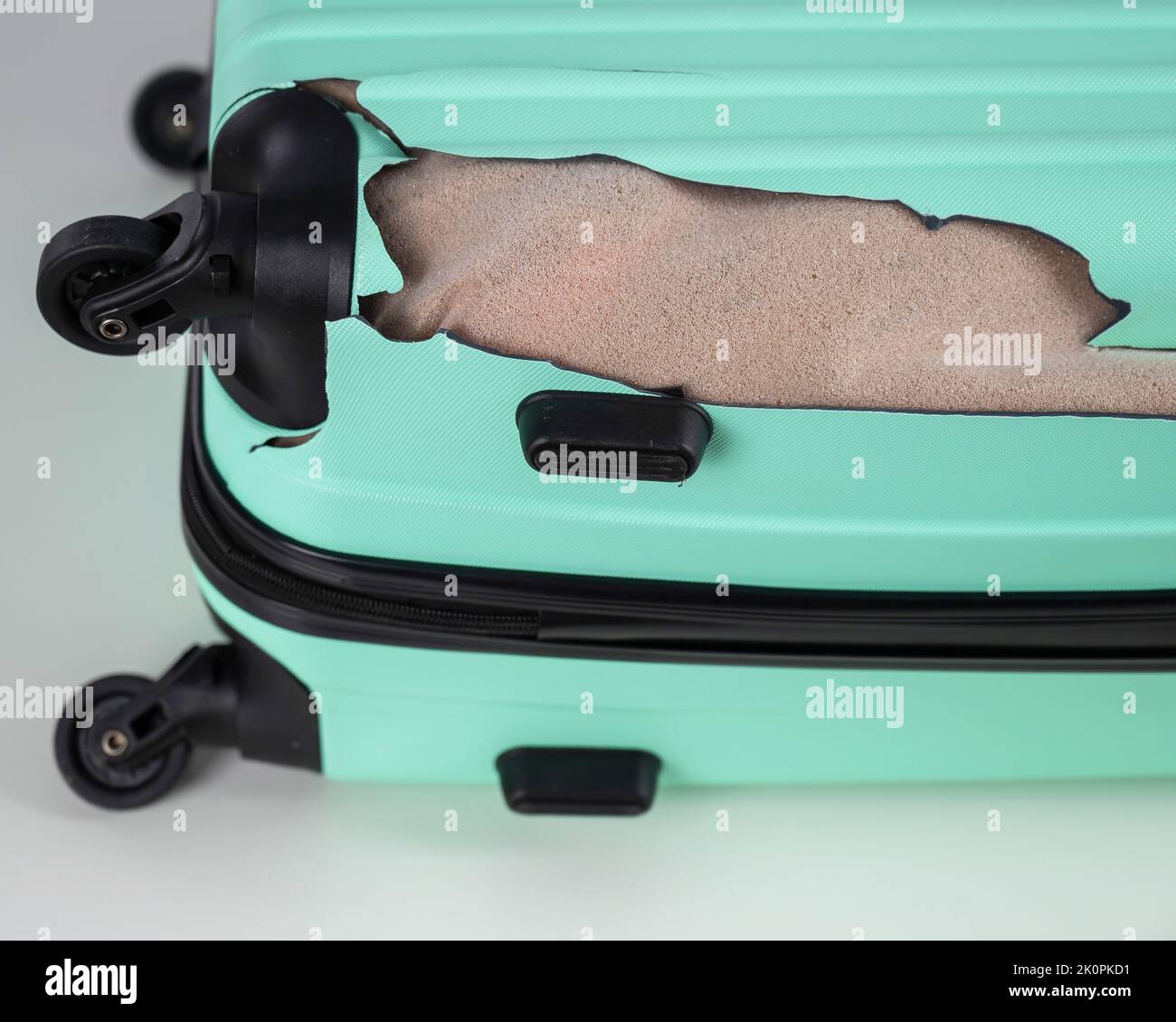 Mint damaged suitcase on a white background Stock Photo - Alamy