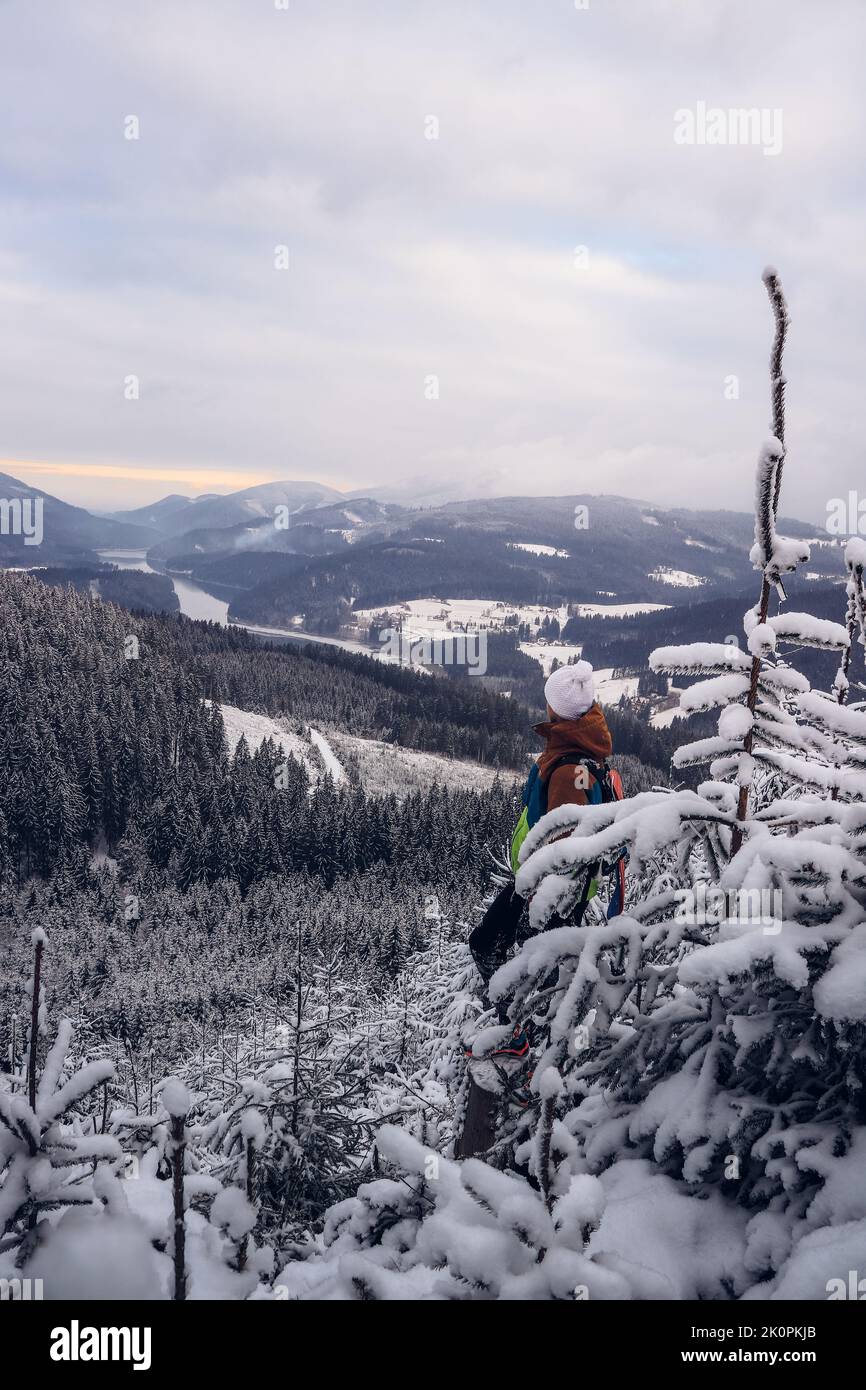 Candid portrait of young smiling man wearing colourful winter hiking ...
