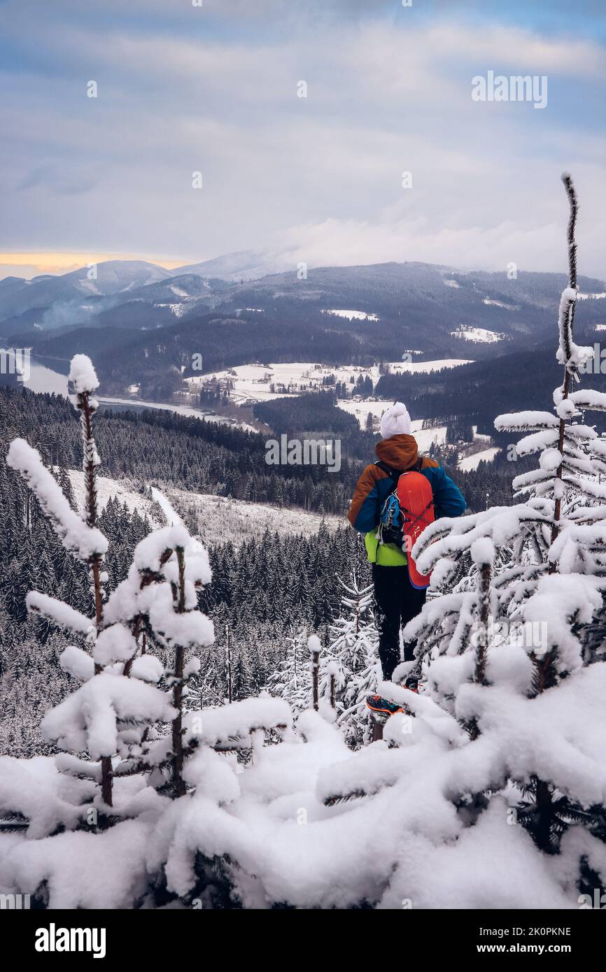 Candid portrait of young smiling man wearing colourful winter hiking ...