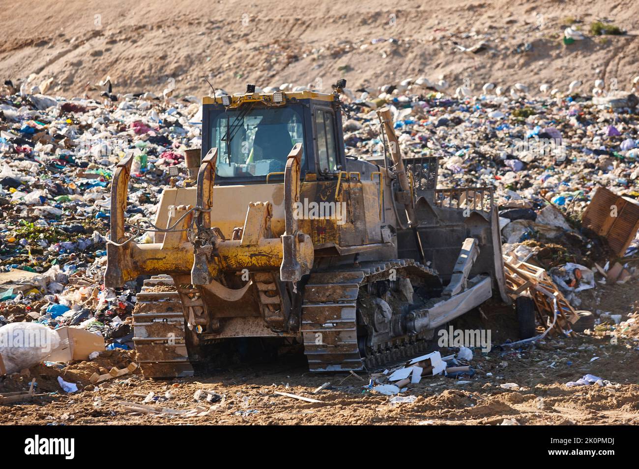 Heavy machinery shredding garbage in an open air landfill. Waste Stock ...