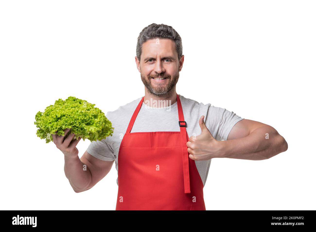 man in apron with lettuce vegetable isolated on white. thumb up Stock ...