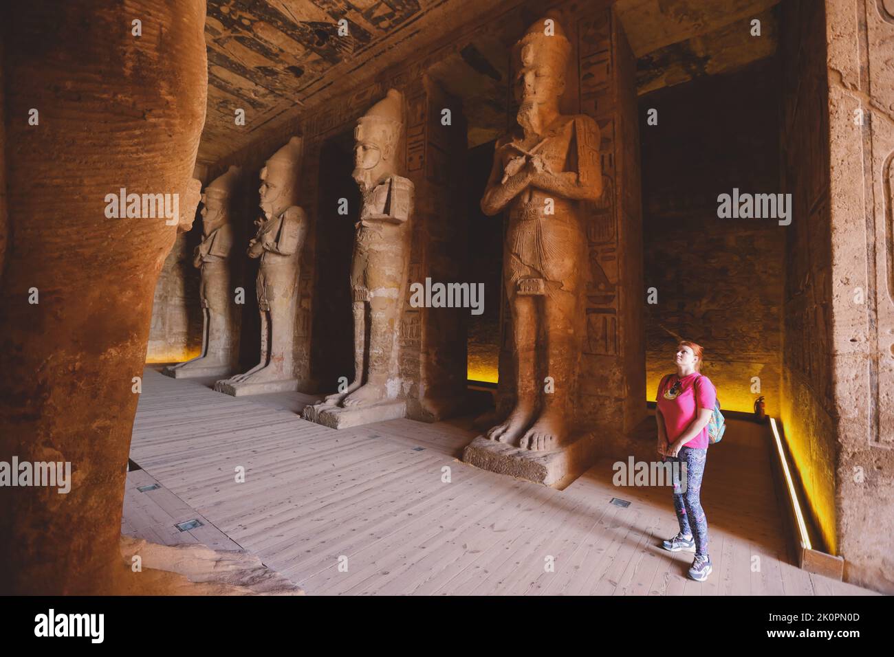 White Tourist in front of the Colossal Statues of Ramesses II seated on ...