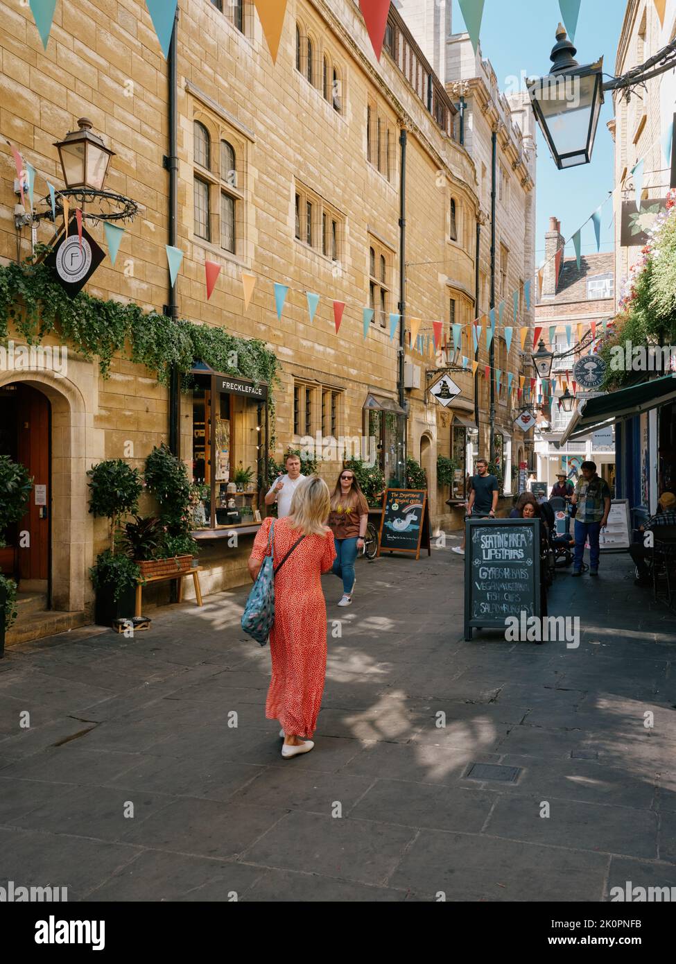 Shoppers, tourists, bunting and the limestone architecture of shop ...