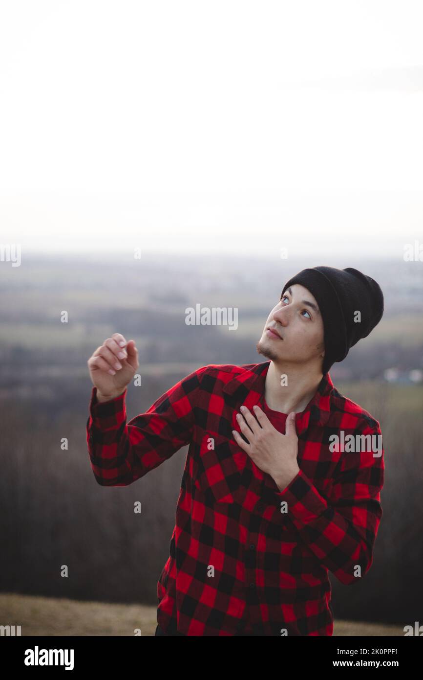 Portrait of a twenty-three year old man in a black and red checked ...