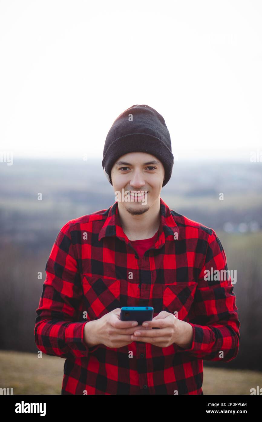 portrait of a twenty-three year old man in a black and red checked ...