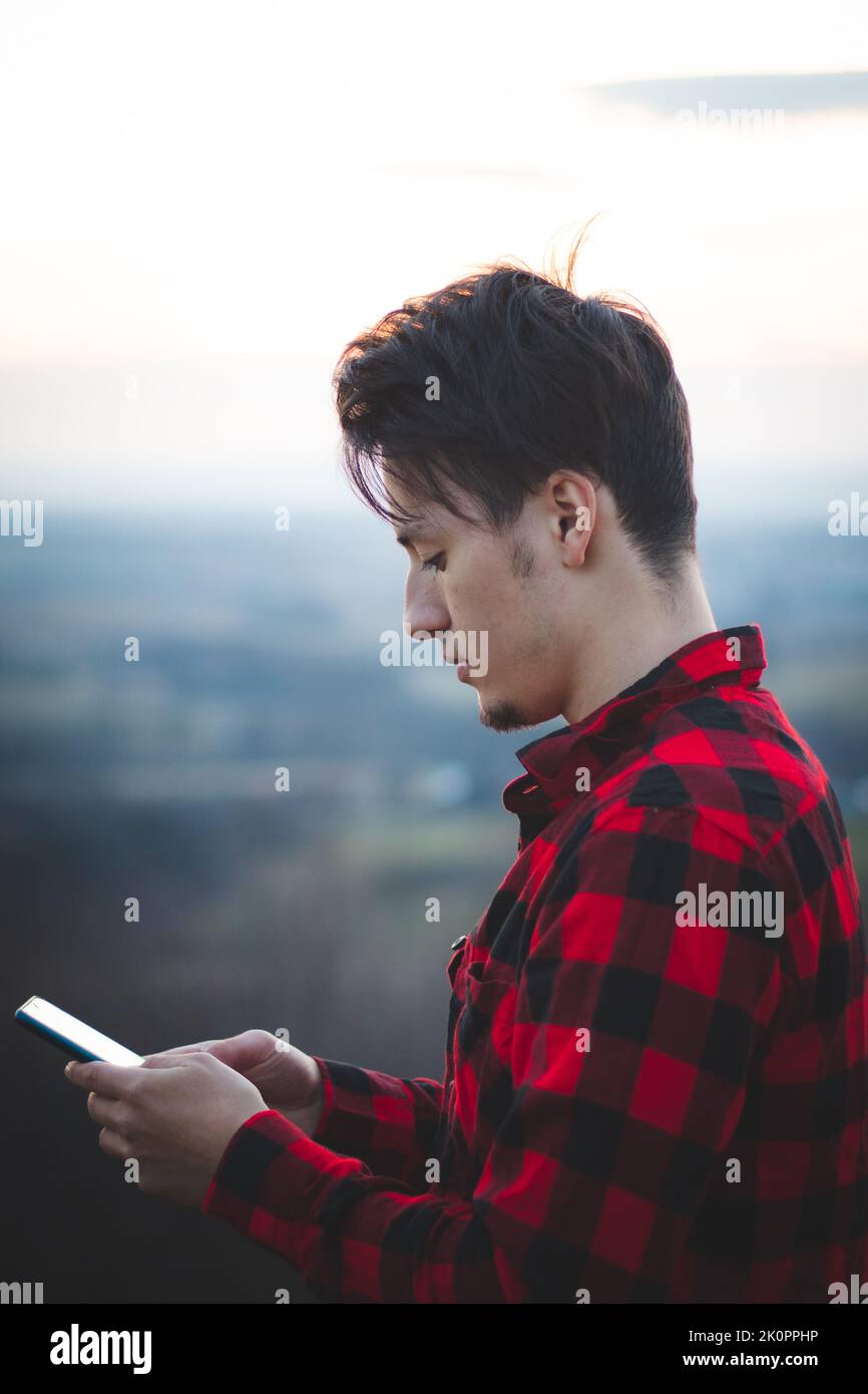 portrait of a twenty-three year old man in a black and red checked ...