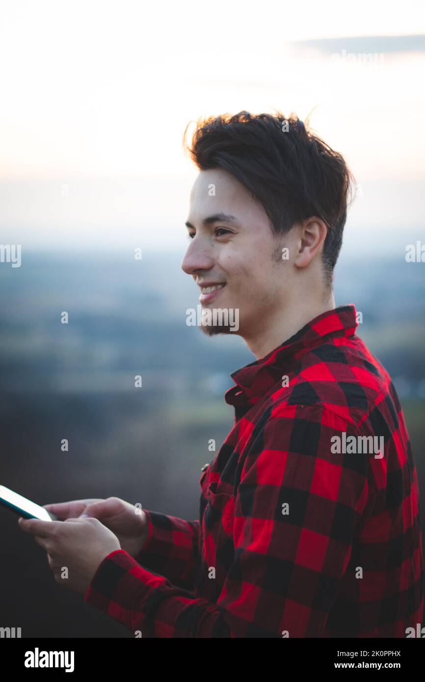 portrait of a twenty-three year old man in a black and red checked ...