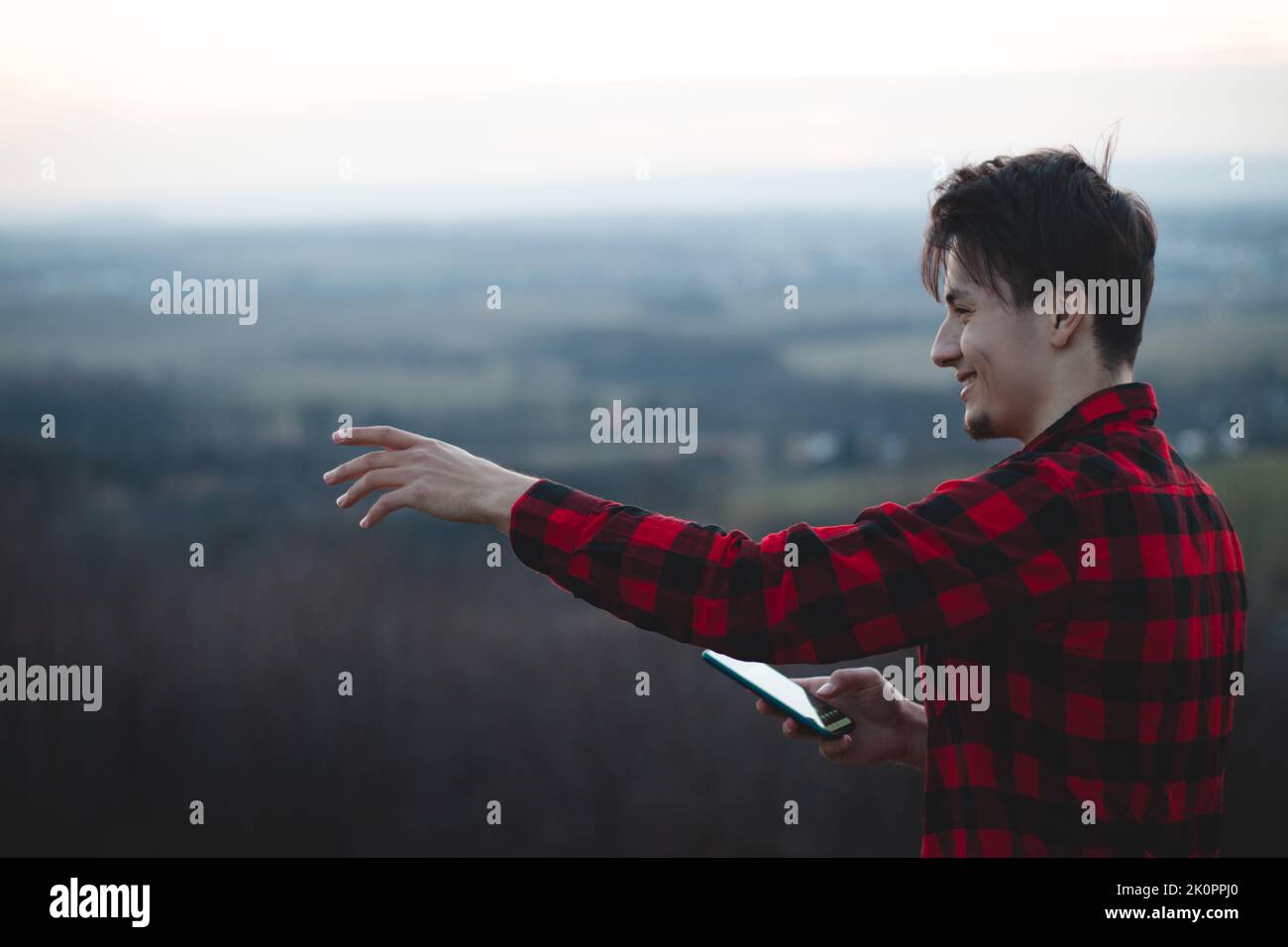 portrait of a twenty-three year old man in a black and red checked ...