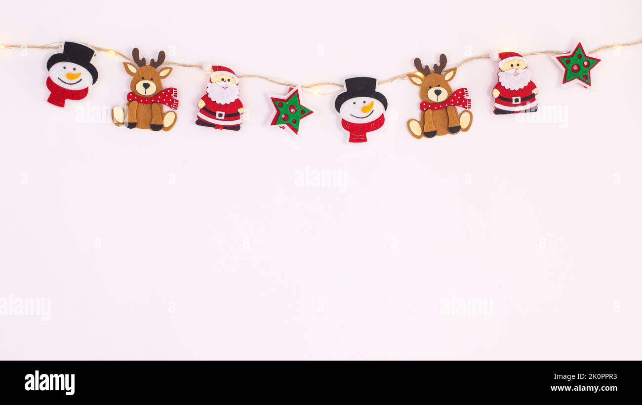 Cute Christmas stickers hanged on rope on white background with copy ...