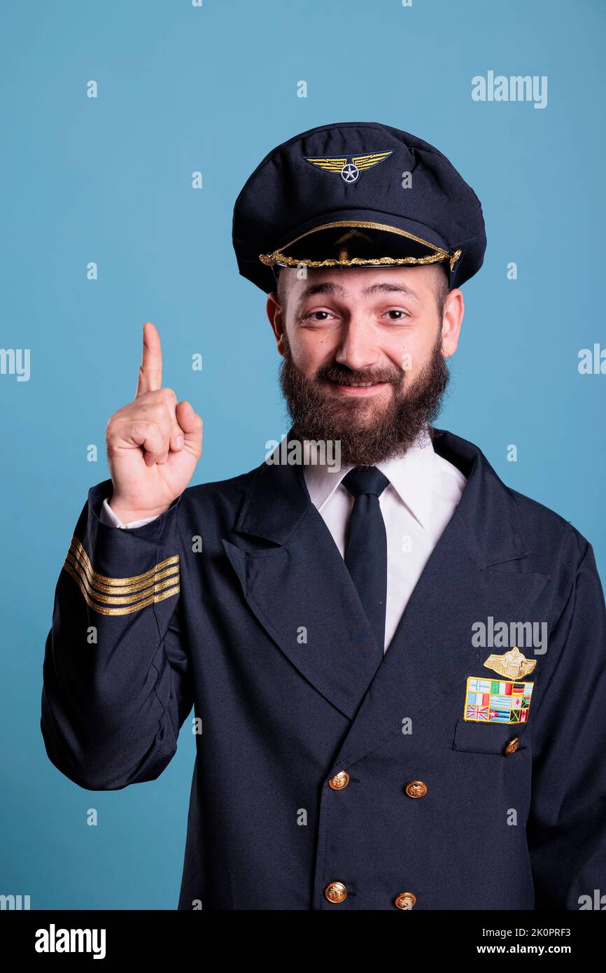 Airplane aviator pointing up with index fingers, advertising product ...
