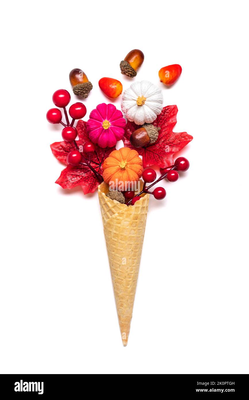 Autumn bouquet of acorns, berries, maple leaves, pumpkins in ice cream ...
