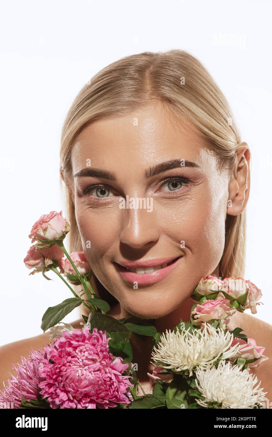 Blossom Close Up Of Beautiful Young Woman With Flower Isolated Over