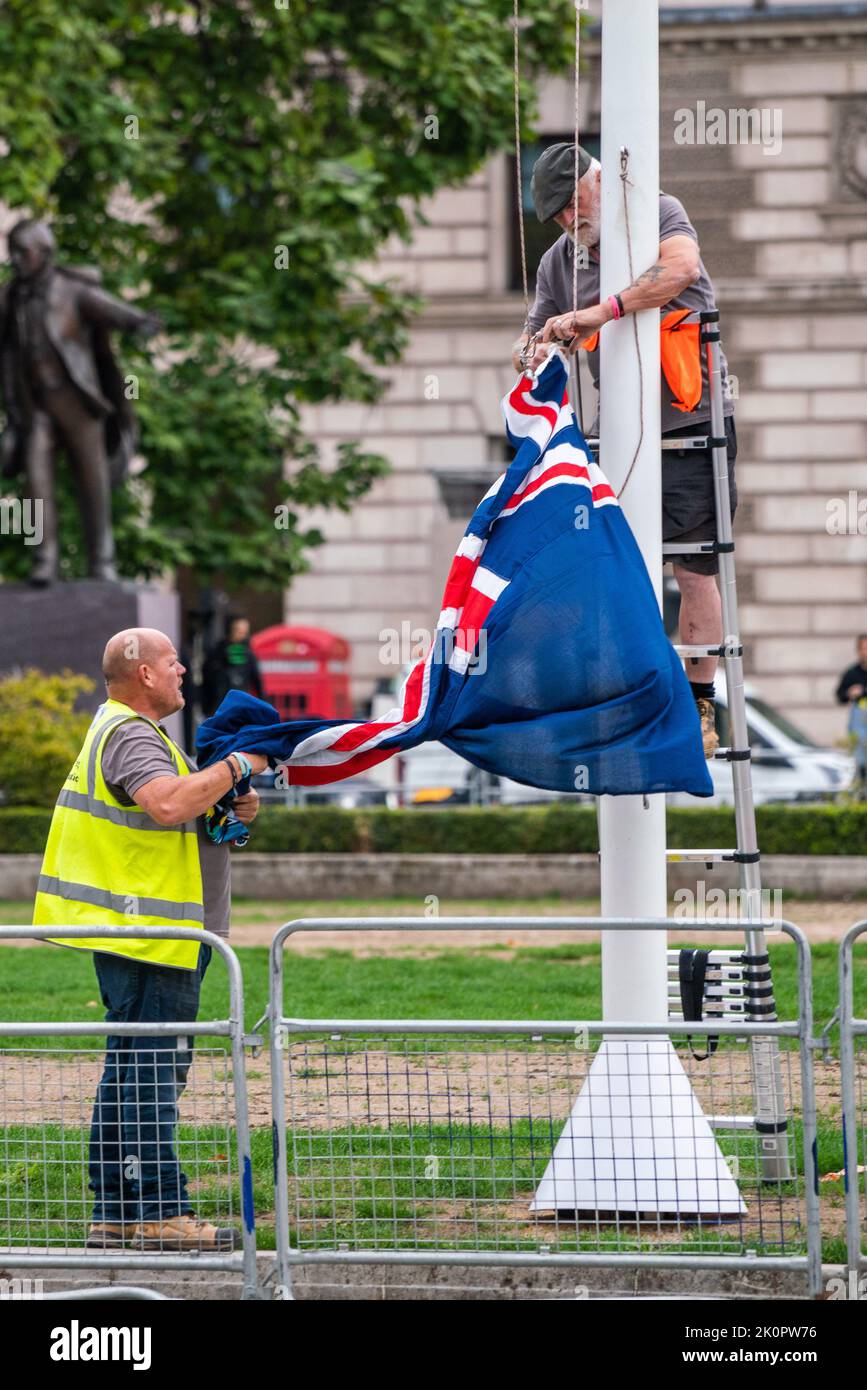 London UK. 13 September 2022. Flags engineers hang the flags of British ...