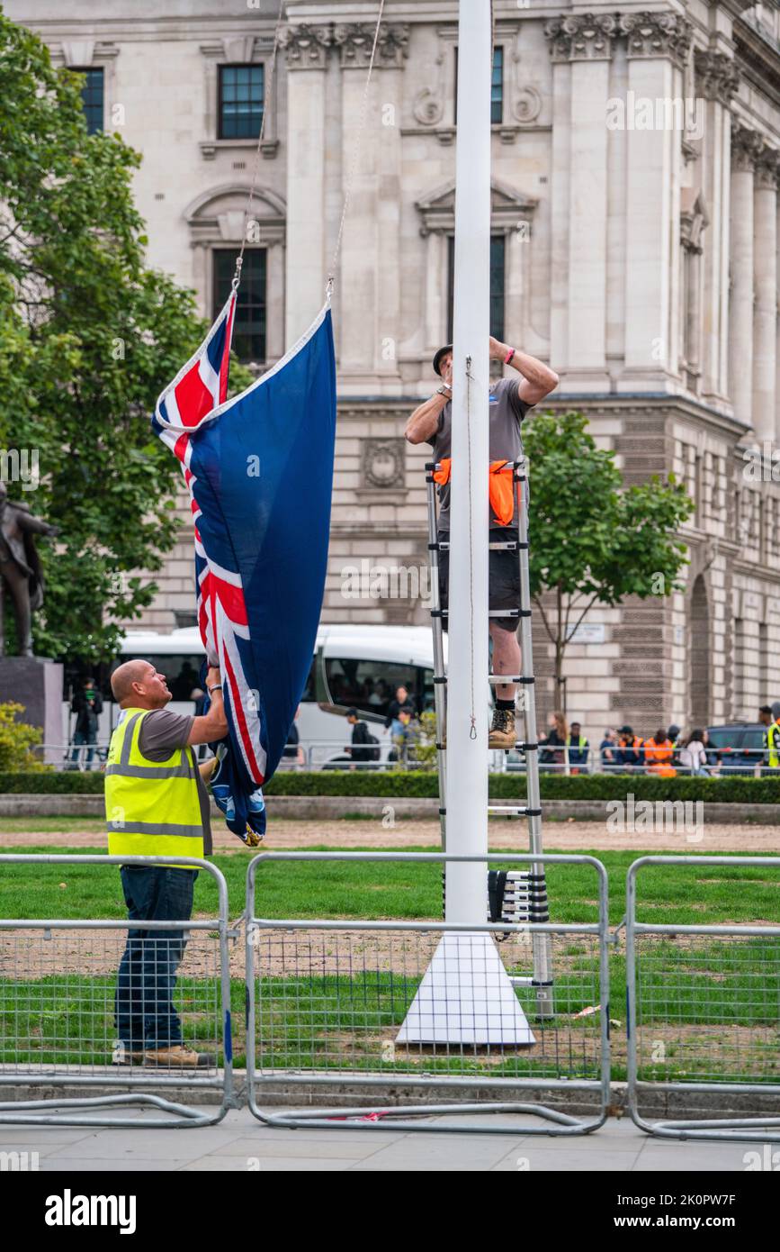 London UK. 13 September 2022. Flags engineers hang the flags of British ...