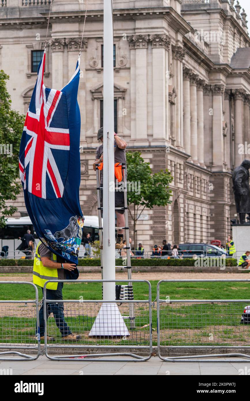 London UK. 13 September 2022. Flags engineers hang the flags of British ...