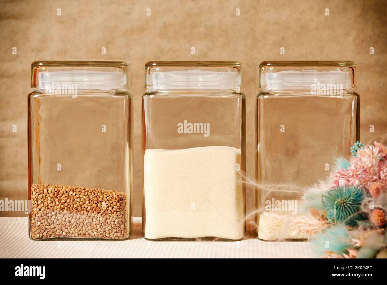 Traditional food and cereals in jars on the kitchen table. Buckwheat ...