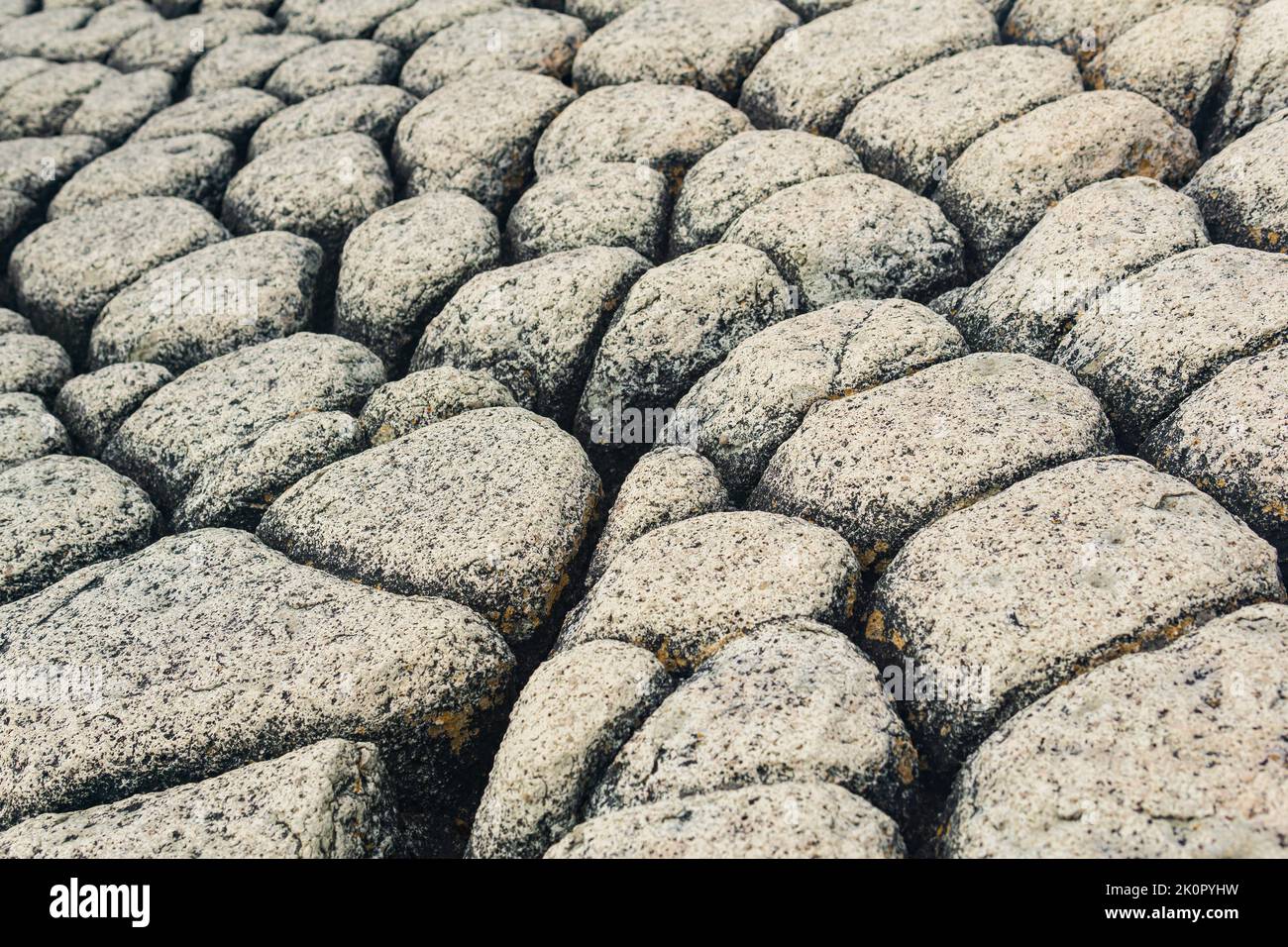 natural stone background, the remains of lava basalt columns form a ...