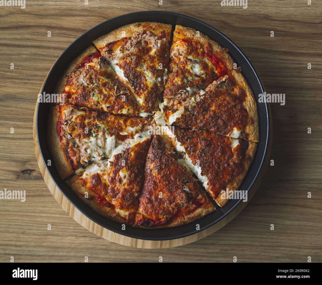 Delicious tuna pizza with anchovies and green pepper. Tasty traditional ...