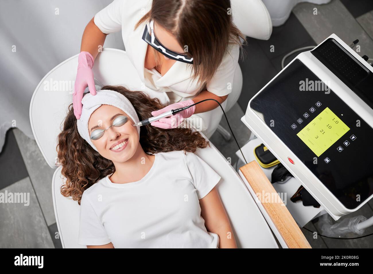 Top view of happy patient with protection for eyes who undergoing laser ...