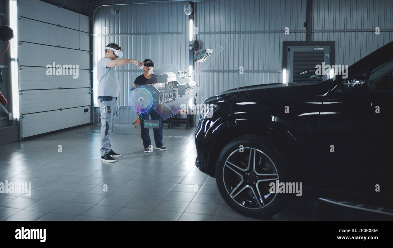 Two technicians check a car engine using virtual reality technology in ...