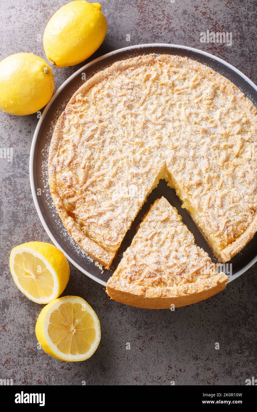 Delicious grated pie with lemon curd close-up in a plate on the table ...