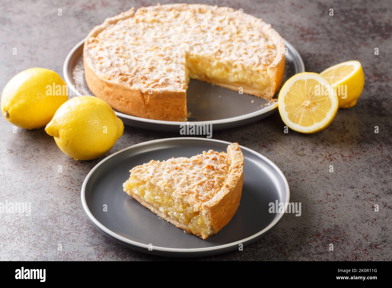 Grated cake Lemon curd pie close-up in a plate on the table. Horizontal ...