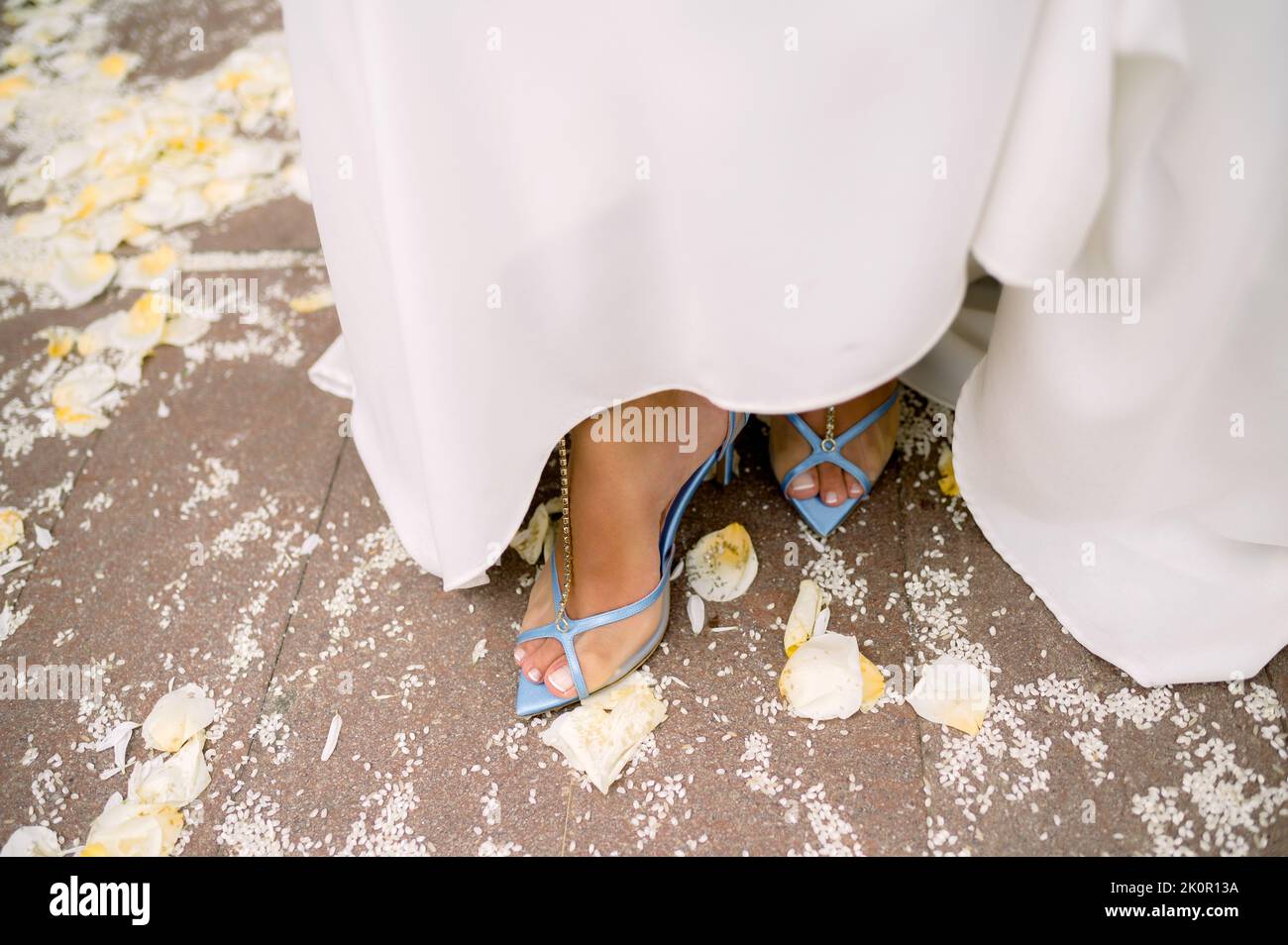 Crop bride walking on flower petals Stock Photo - Alamy