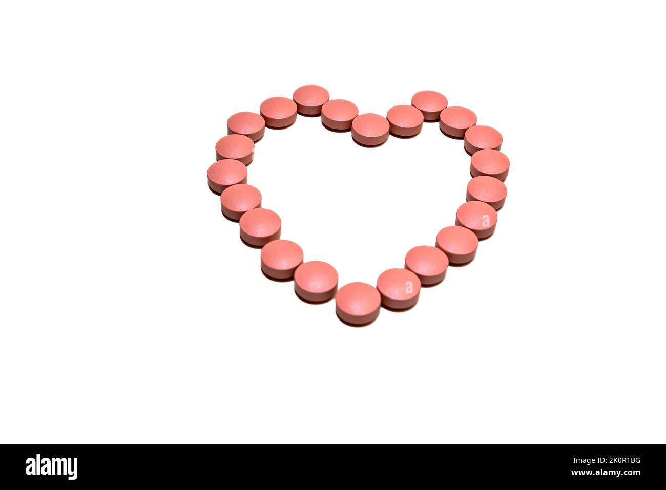 Pink pills forming a heart. Pharmacist, medicine Stock Photo - Alamy