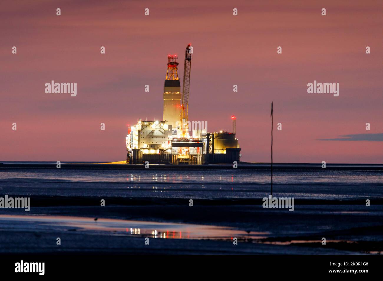 Germany's only oil rig "Mittelplate" at night Stock Photo - Alamy